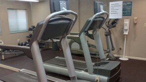 Centro de ginástica com esteiras e equipamentos de exercício.