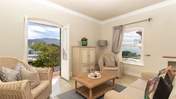 Suite Deluxe, 1 quarto, varanda | Sala | Televisor