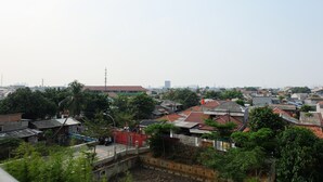 Um bairro residencial com casas, algumas com telhados vermelhos, e algumas árvores.