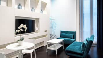 Quarto Deluxe, Vista para a cidade | Sala de estar | TV de ecrã plano