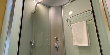 Um secador de cabelo, chinelos, sanita com bidé eletrónico 