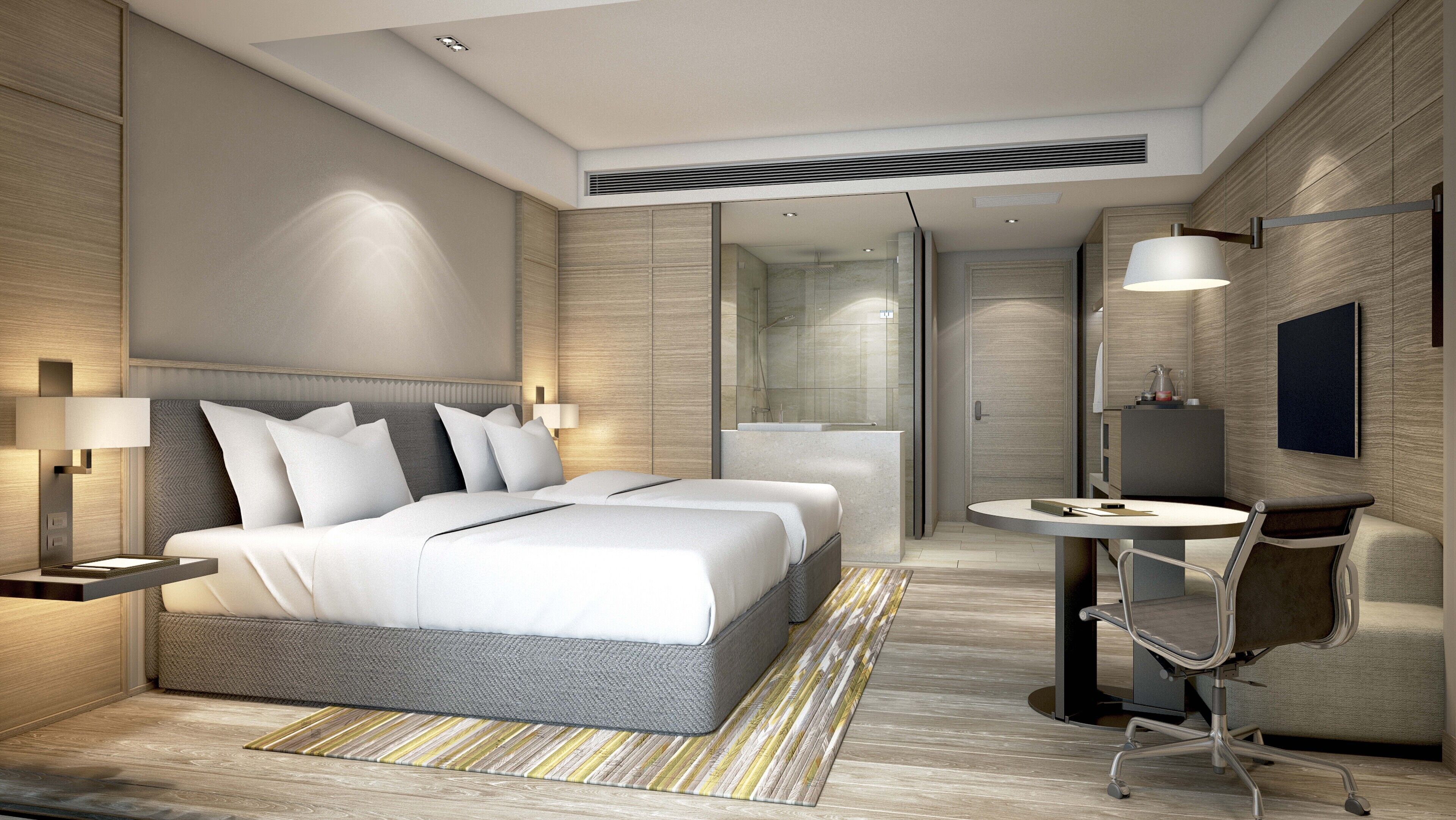 Quarto de hotel moderno com uma cama grande, mesas de cabeceira, escrivaninha com cadeira, área de chuveiro e televisão fixada na parede.