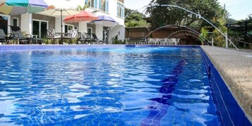 Piscina externa, guarda-sóis, espreguiçadeiras