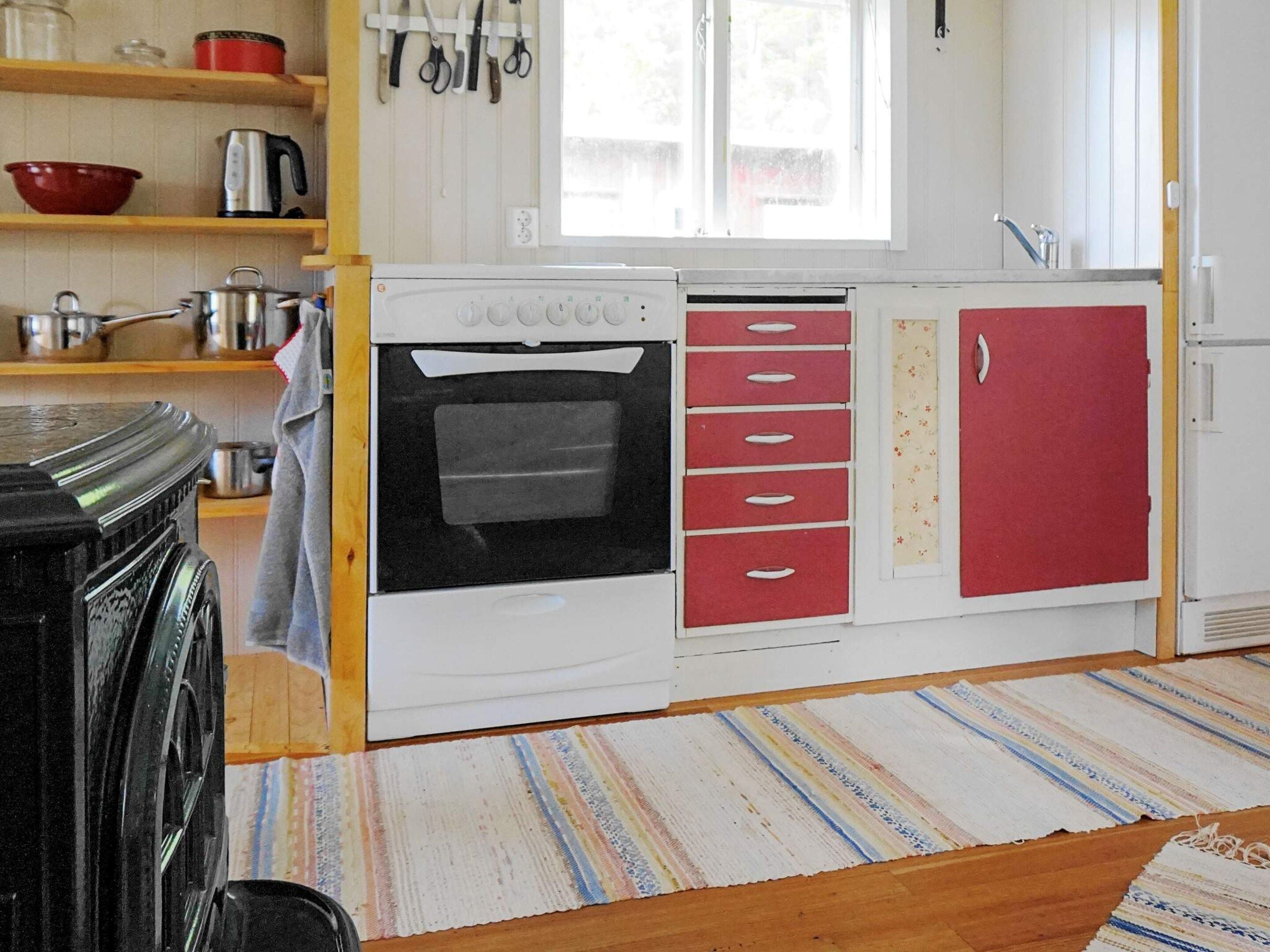 Uma cozinha com fogão, forno e armários.