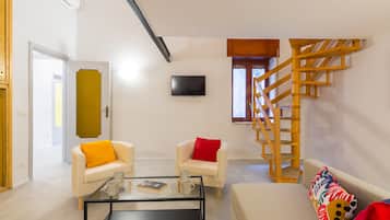 Apartamento Deluxe | Sala de estar | TV de ecrã plano