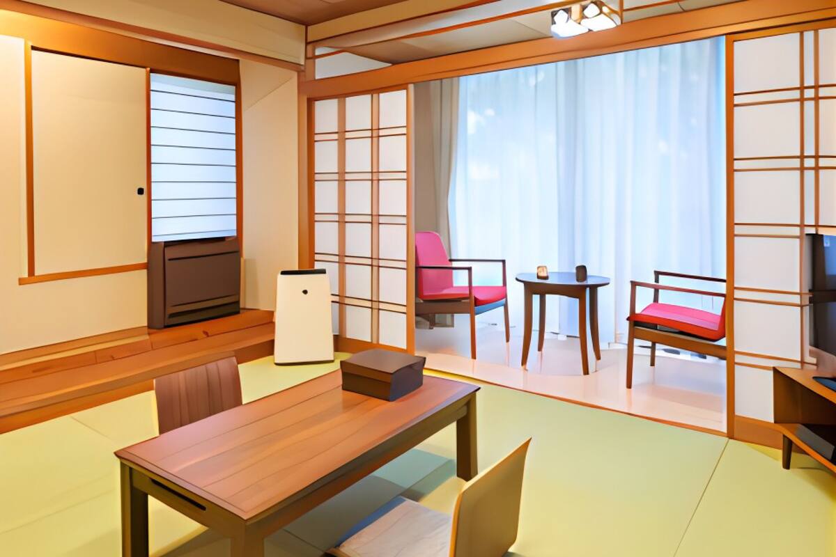 Um quarto em estilo japonês tradicional, com tatames, uma mesa de madeira baixa e cadeiras vermelhas.