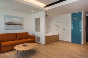 Uma sala de estar moderna com um sofá, mesa de centro e um quadro na parede.