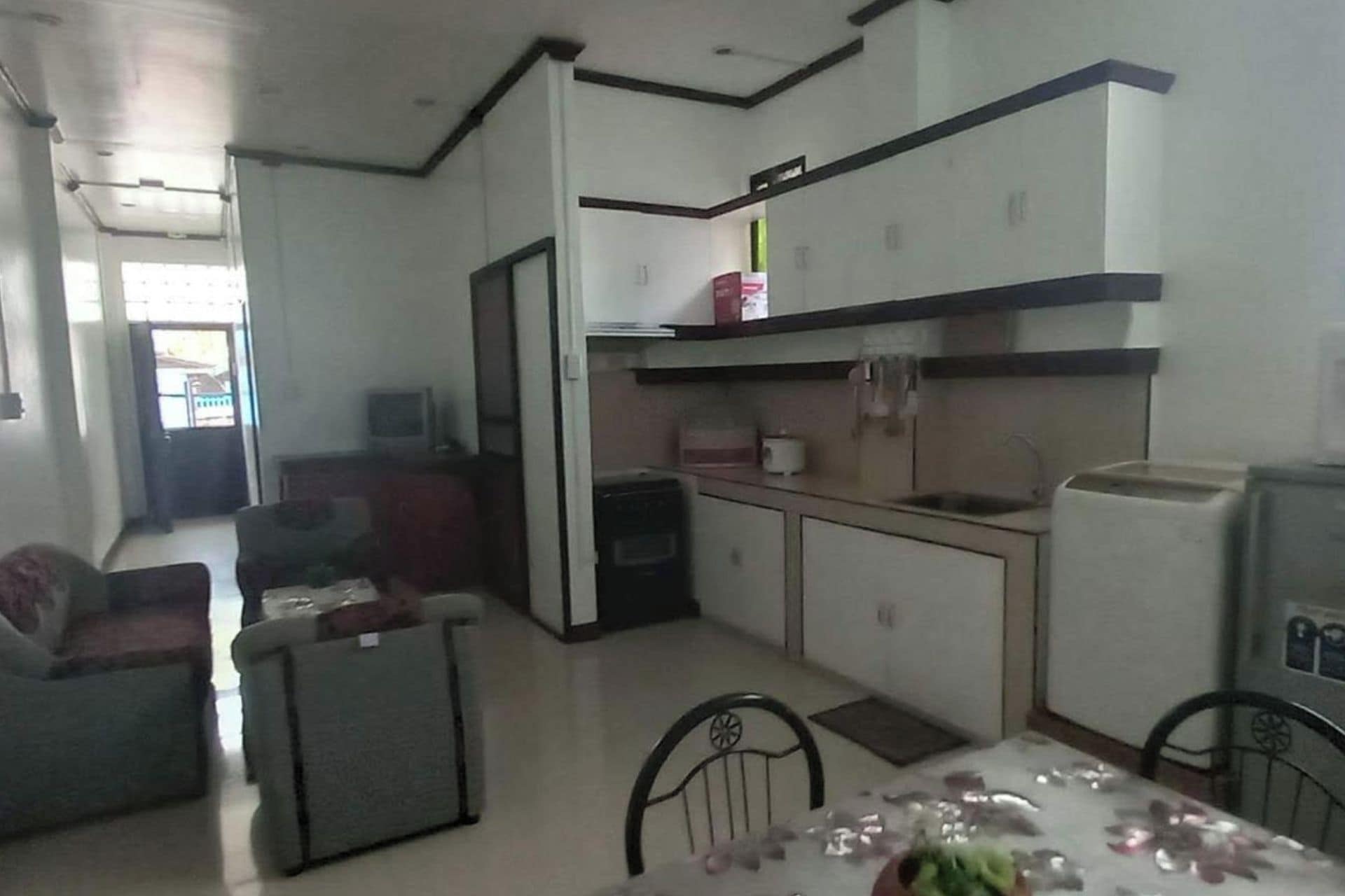 Um espaço compacto com cozinha compacta, área de refeições e um pequeno espaço para sentar.