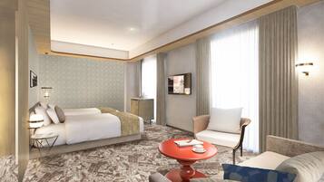 Quarto de hotel moderno com uma cama, um sofá, uma mesa pequena com xícara e pires, uma cadeira e uma televisão na parede.