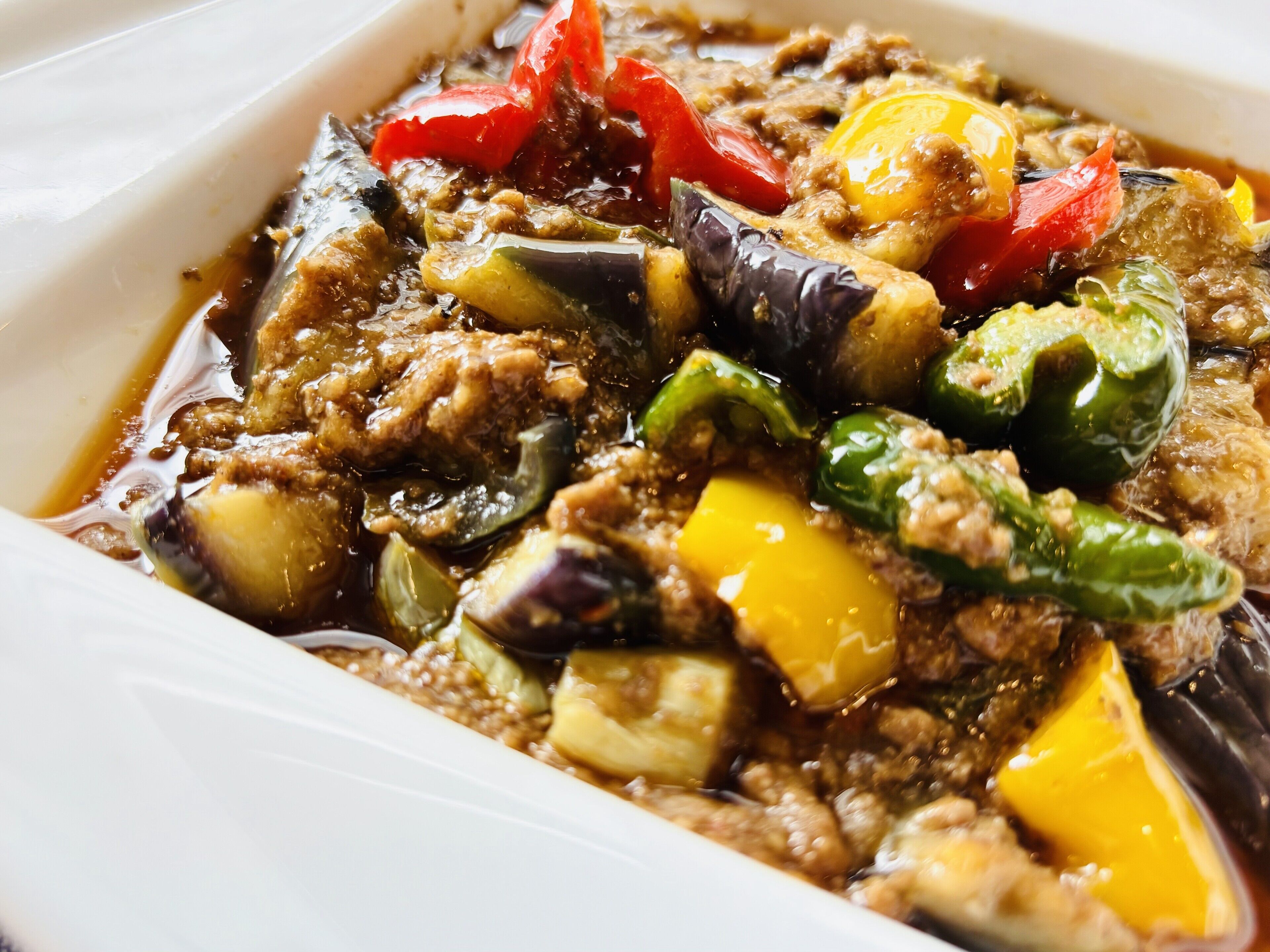 Prato com v ários vegetais e carne em uma tigela branca.
