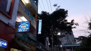 Um edifício com vários andares e placa indicando 'Pari Deluxe Lodge', com ar condicionado, quartos para não fumantes, quartos familiares e estacionamento disponível.