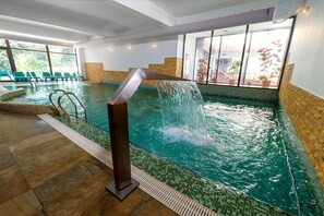 Piscina interna, guarda-sóis, espreguiçadeiras