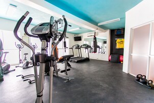 Uma academia com equipamentos de ginástica, esteiras e pesos.