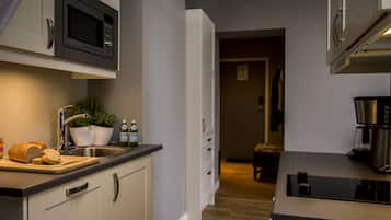 Um frigorífico, um micro-ondas, um forno, uma placa de cozinha