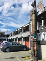 Um edifício com um toleiro, um carro estacionado em frente e uma placa indicando 'Thunderbolt Motor Inn'.