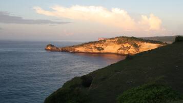 Paisagem costeira com falésias e vista para o mar.