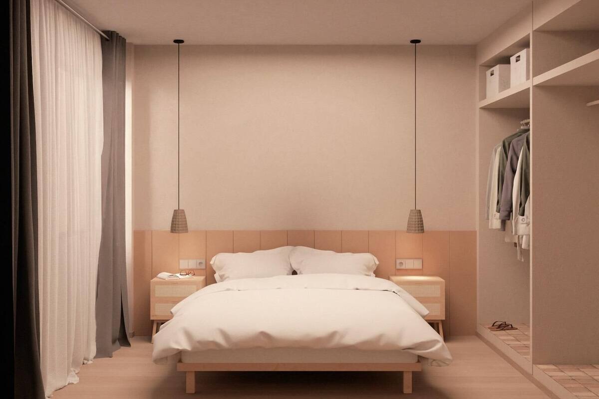 Quarto com cama, mesas de cabeceira, guarda-roupa e luminária pendente.