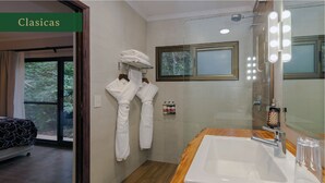 Casa de banho moderna com uma grande pia, espelho e porta-toalhas.