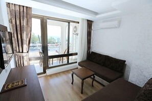 Suíte família, 1 quarto, vista para o mar | Área de estar | TV LED 82 cm com canais via satélite, TV