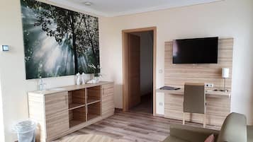Suíte conforto, 1 cama King | Área de estar | TV de tela plana
