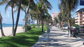 Na praia, praia de areia branca, guarda-sóis de praia, toalhas de praia 