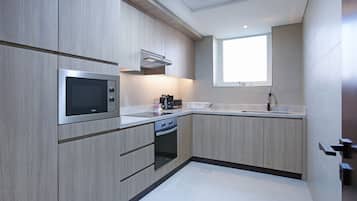Um frigorífico/congelador grande, um micro-ondas, um forno
