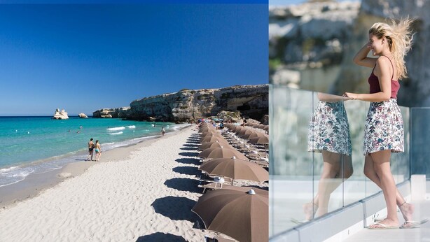 Uma praia com águas azul-claras, falésias rochosas e guarda-sóis.