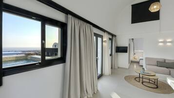 Uma sala de estar moderna com uma janela grande, um sofá, uma mesa de centro e vista para uma piscina e um edifício.