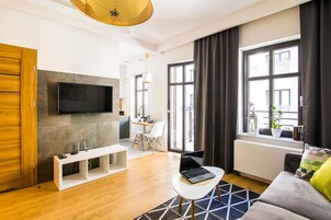 Apartamento empresarial | Área de estar | TV LCD