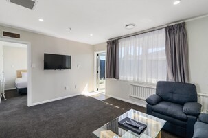 Apartamento executivo, 2 quartos | Área de estar | TV de tela plana 43 polegadas com canais via satélite, TV