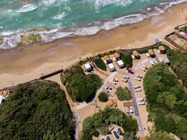 Na praia, praia de areia branca, espreguiçadeiras, guarda-sóis de praia