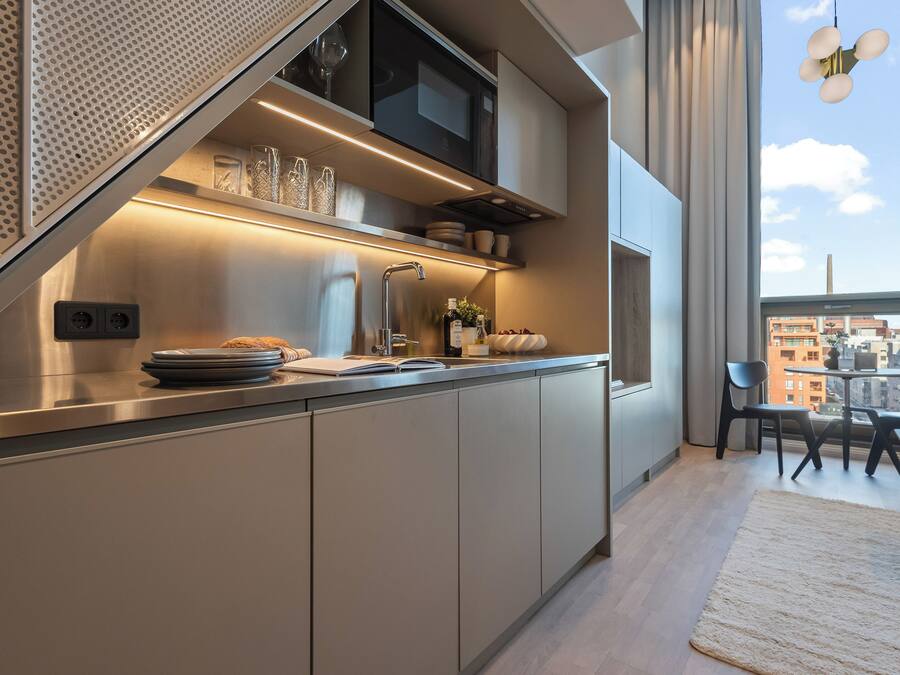 Uma cozinha moderna com eletrodomésticos embutidos, um espaço de refeições com vista e um ambiente acolhedor para relaxar.