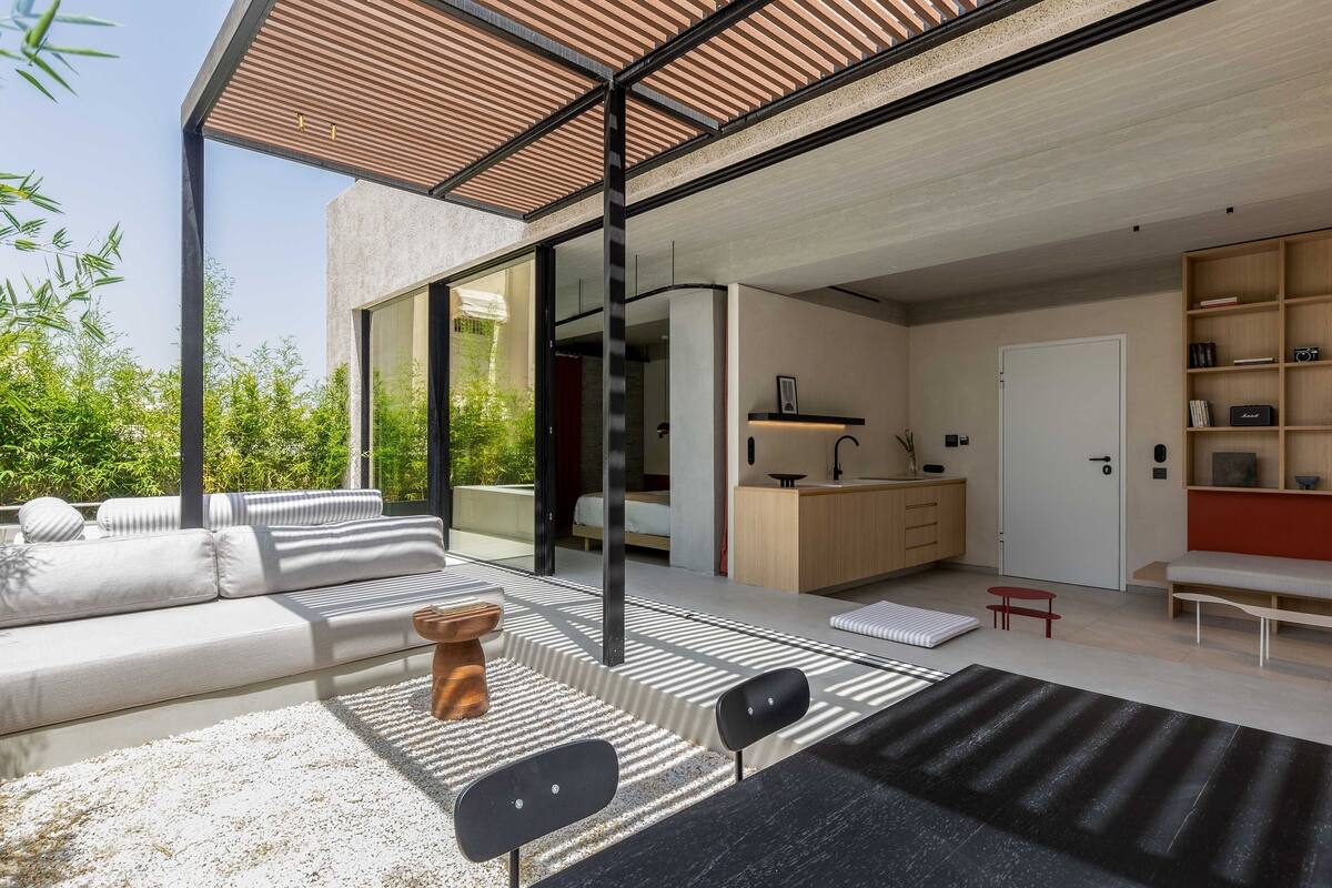 Um interior moderno com um sofá, uma mesa de jantar e uma área de cozinha.