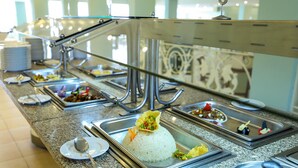 Disposição de buffet com diversos alimentos e utensílios.