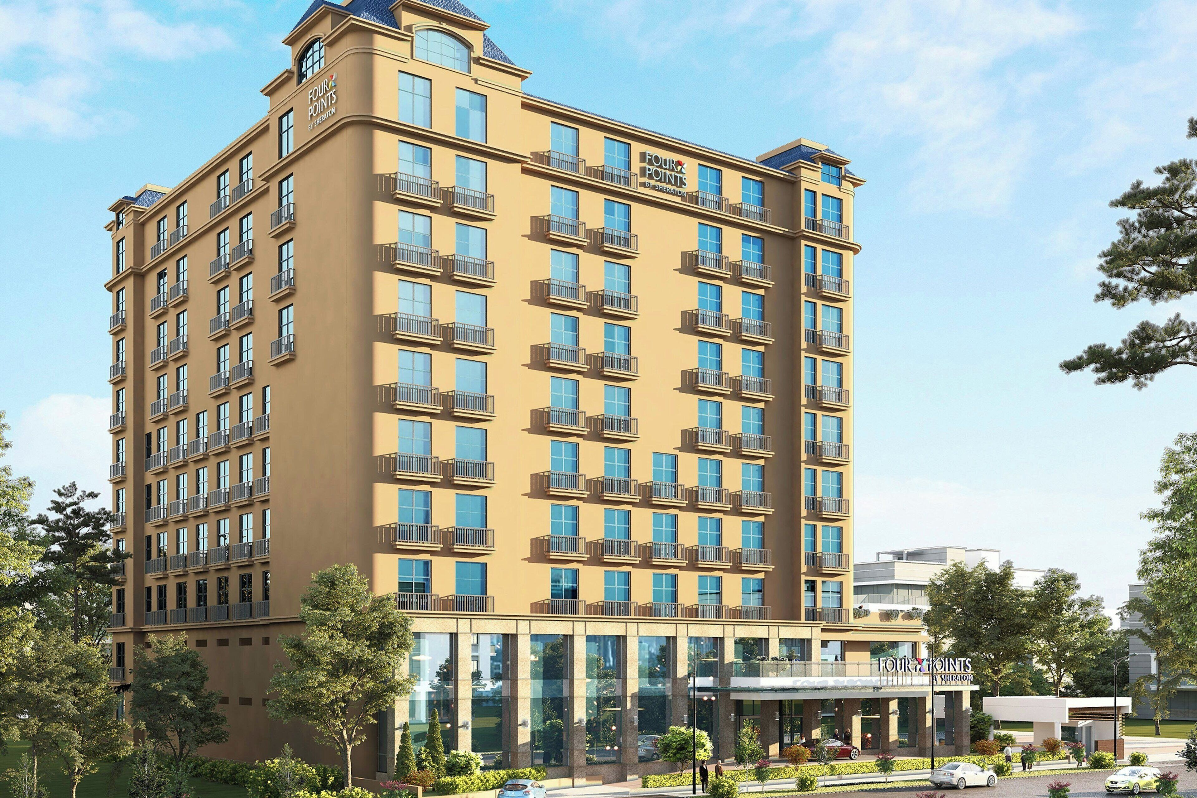 Hotel com vários andares, fachada bege, inúmeras varandas e design arquitetônico moderno.