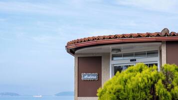 Um edifício com uma placa que diz “Andora” e vista para o mar ao fundo.