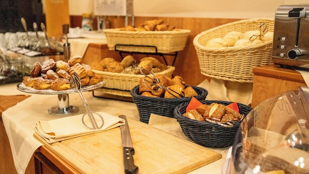 Buffet com diversos produtos de panificação e uma torradeira.