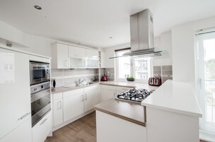 Apartamento, 2 quartos | Cozinha privada | Geladeira, micro-ondas, cooktop, lava-louças