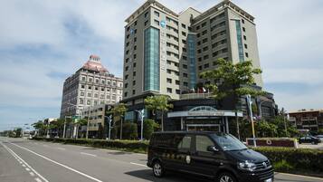Um edifício moderno com vários andares e uma entrada destacada.