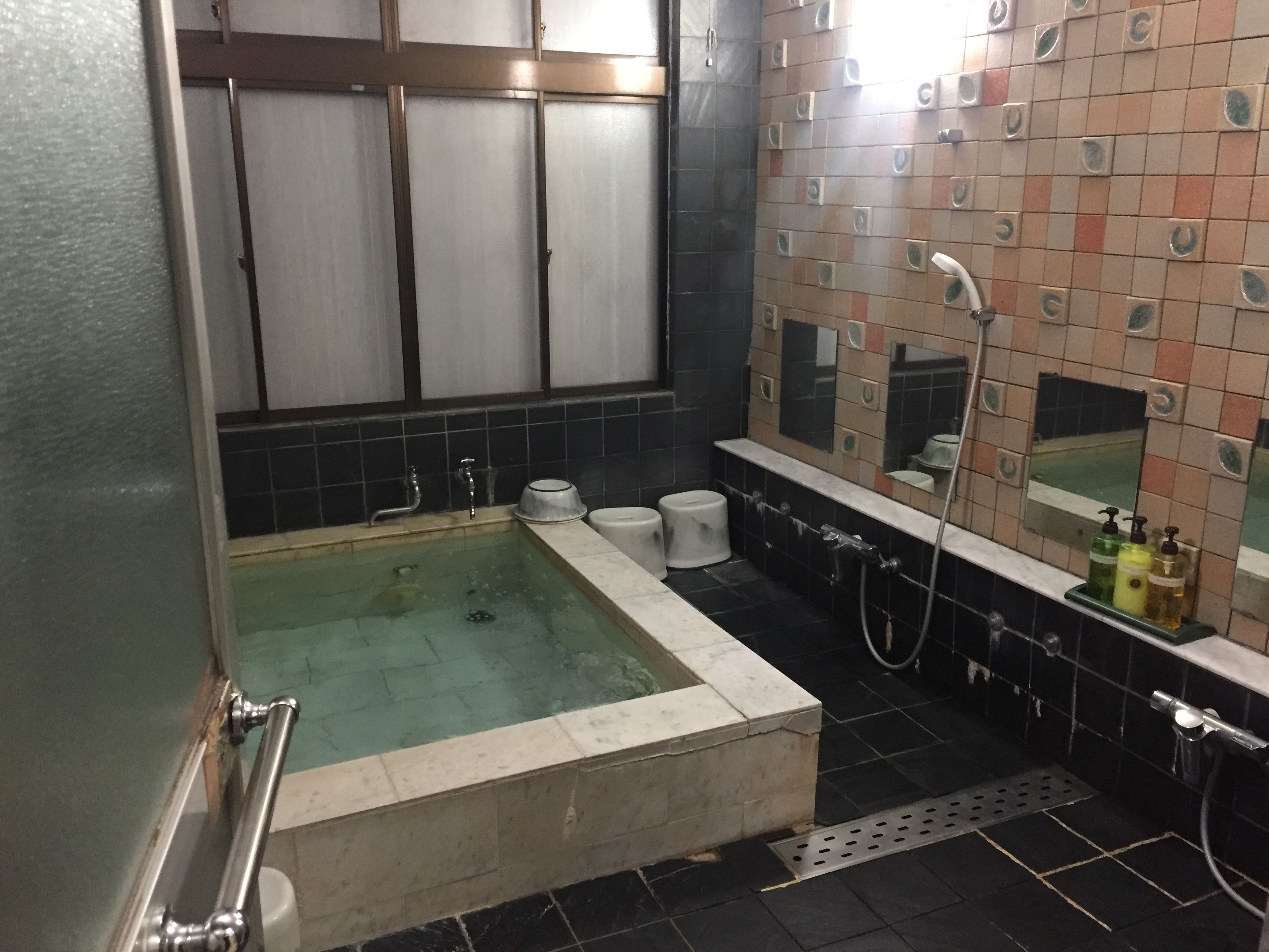 Uma casa de banho com banheira, sanita e chuveiro.