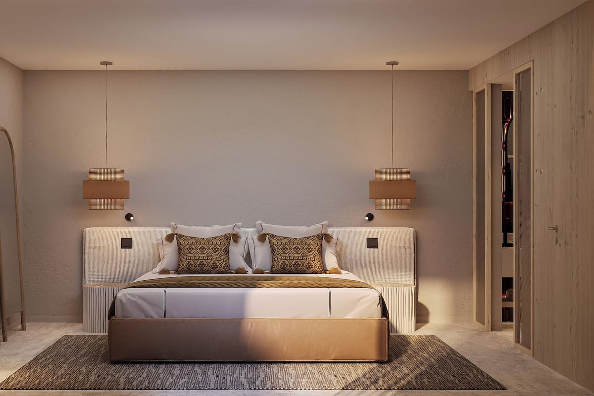 Quarto moderno com cama grande, duas luminárias fixadas na parede e um guarda-roupa de madeira.