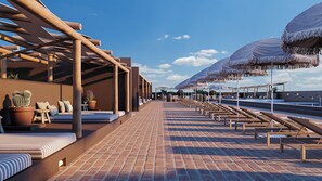 Terraço no telhado com pérgulas de madeira, cadeiras de descanso e plantas em vasos.