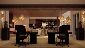 Uma área de refeições moderna com duas cadeiras pretas, uma mesa redonda e luminárias pendentes.