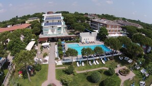 Hotel com piscina, área de estar externa e painéis solares.