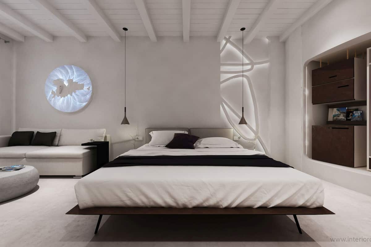 Quarto moderno com cama grande, sofá, decoração circular na parede e armário.
