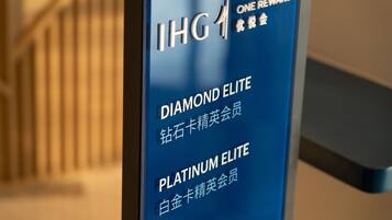 Sinal indicando 'IHG Diamond Elite' e 'Platinum Elite', diferenciando categorias de quarto de hotel.