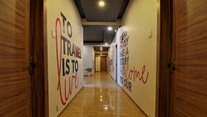 Corredor com portas e paredes de madeira adornadas com frases motivacionais.