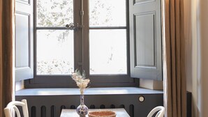 Quarto com janela, uma mesa e duas cadeiras.