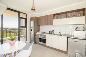 Apartamento Deluxe | Cozinha privada | Um frigorífico, um micro-ondas, um forno, uma placa de cozinha 
