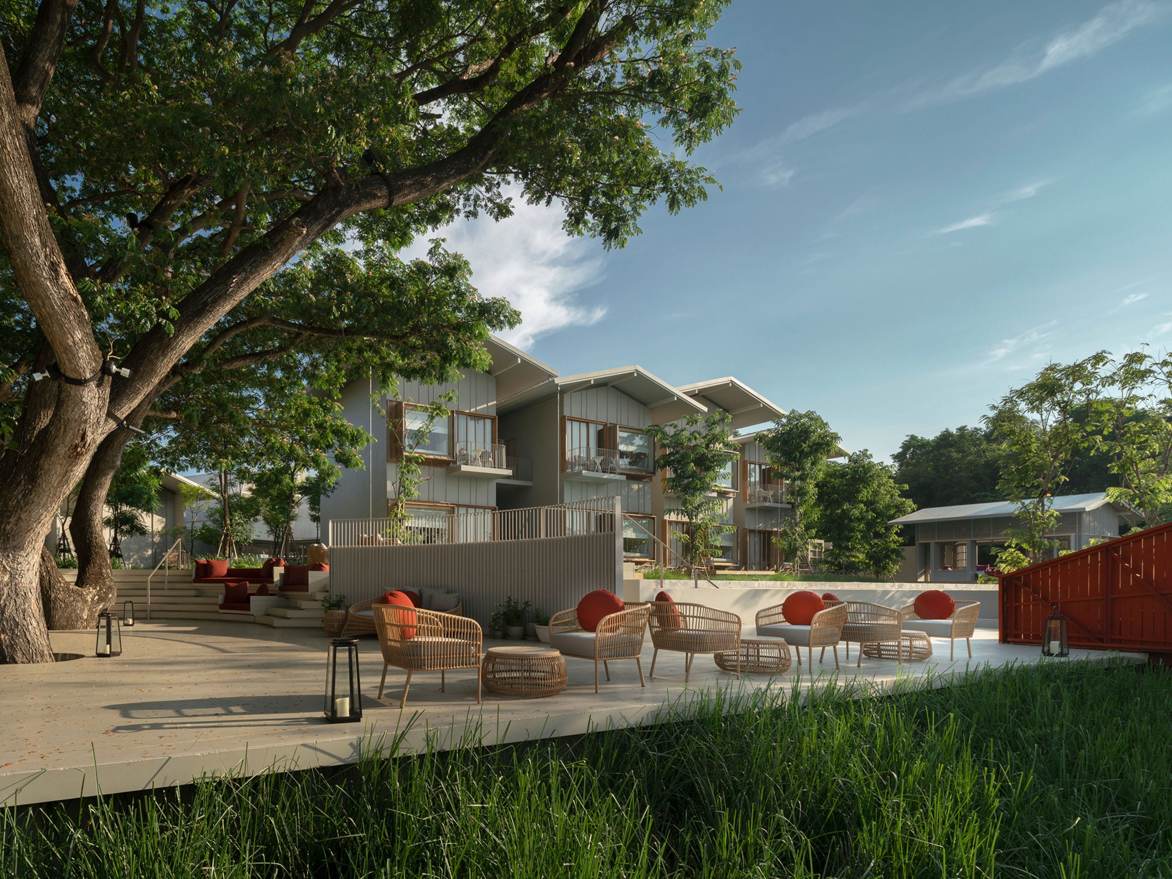 Um edifício residencial moderno com várias varandas, área de estar ao ar livre e um jardim bem cuidado.